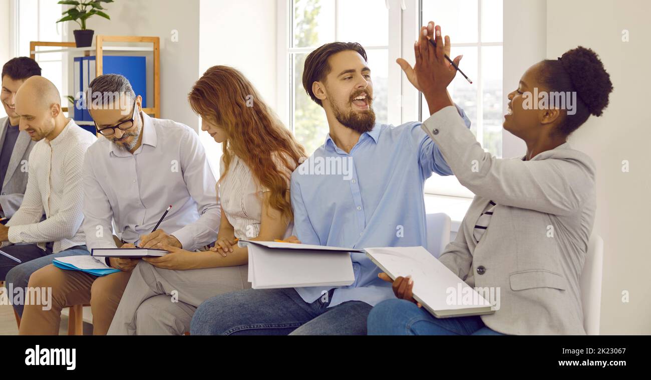 Cheerful colleagues give each other after successfully completed task ...