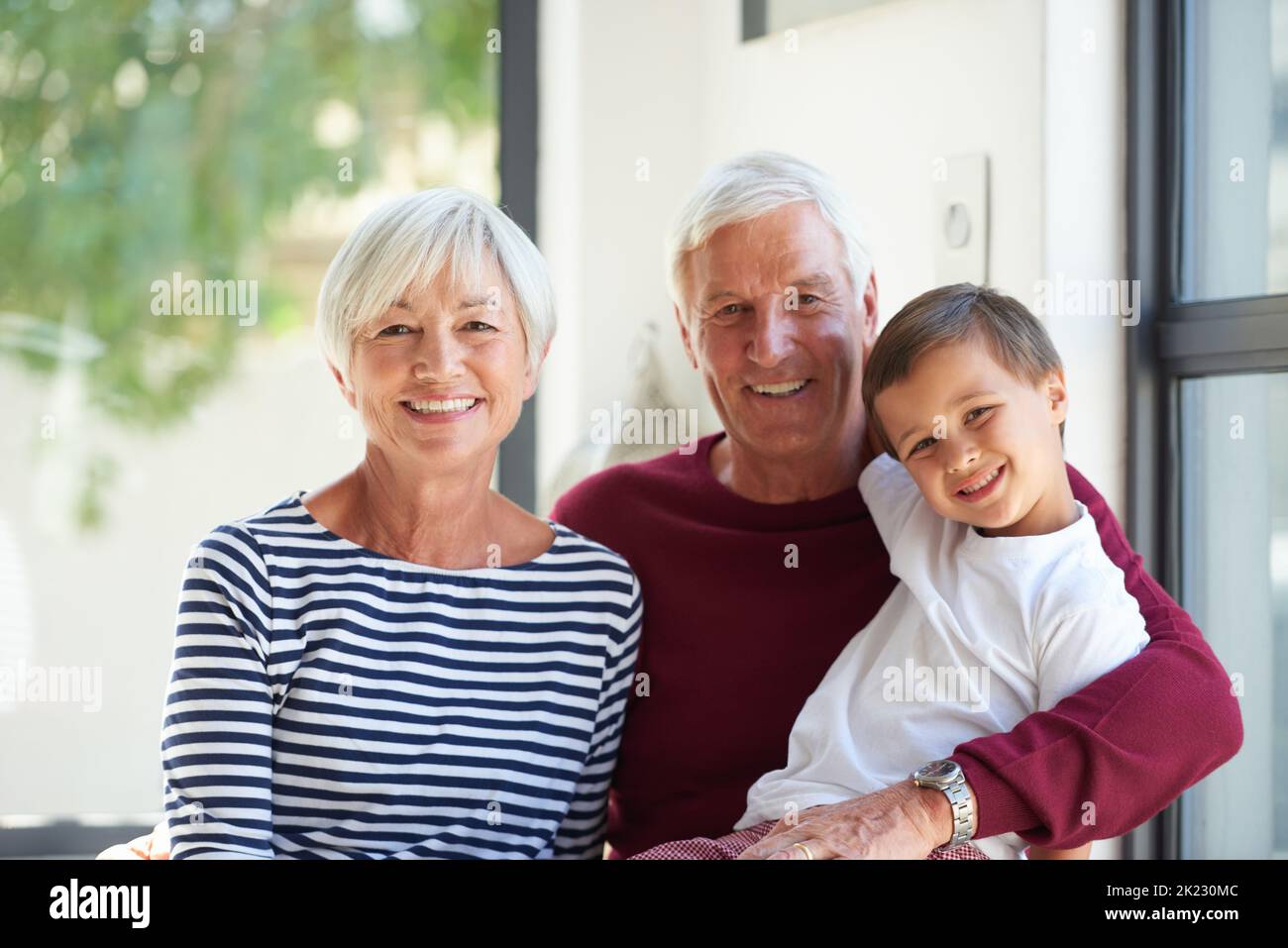 We love it when our grandson visits. Portrait of a senior couple and ...