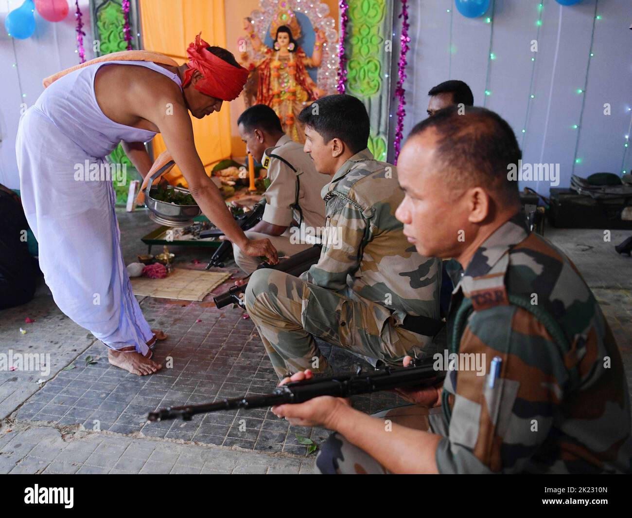 A priest blessing weapons belonging to TSR 2nd Battalion (Tripura State ...