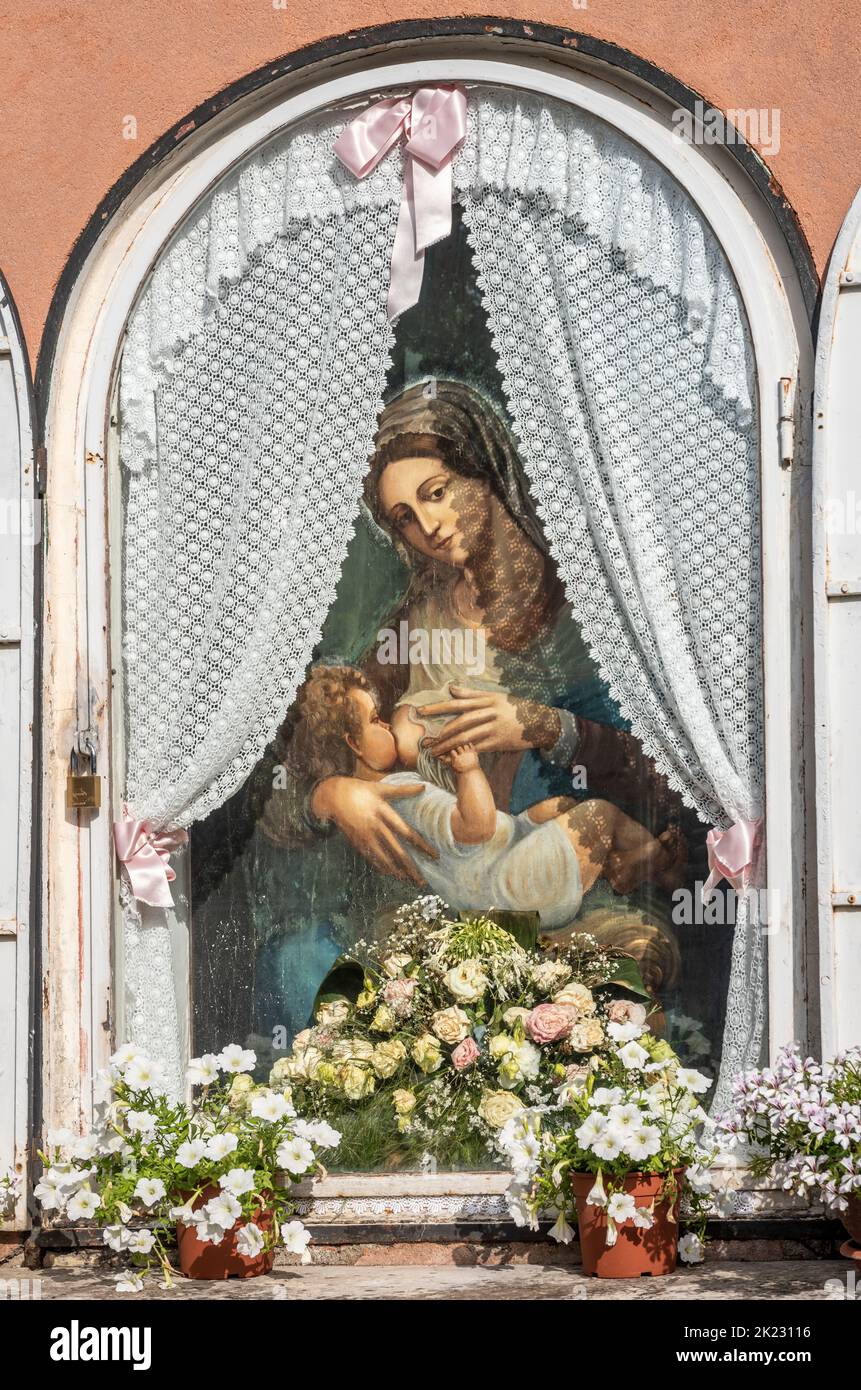 A roadside shrine in Sicily, Italy, showing the Nursing Madonna ...