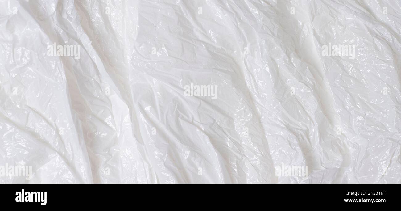 White plastic wrap background. Crumpled wrinkled plastic cellophane ...