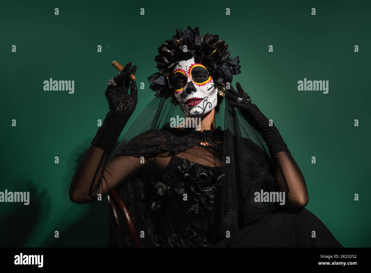 Woman with creepy santa muerte costume holding cigar and posing on ...