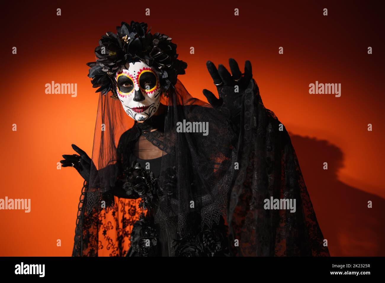 Woman in creepy santa muerte costume and wreath looking at camera on ...