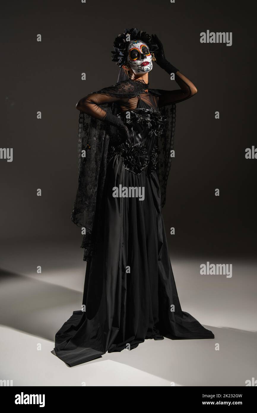 full length of woman with traditional mexican santa muerte makeup and ...