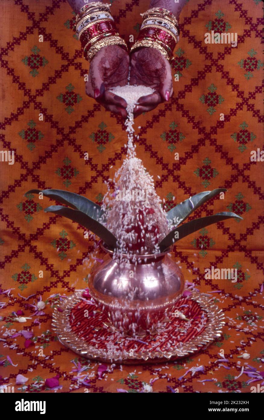 Hindu Wedding, Rice Being Poured Over The Kalash Stock Photo - Alamy