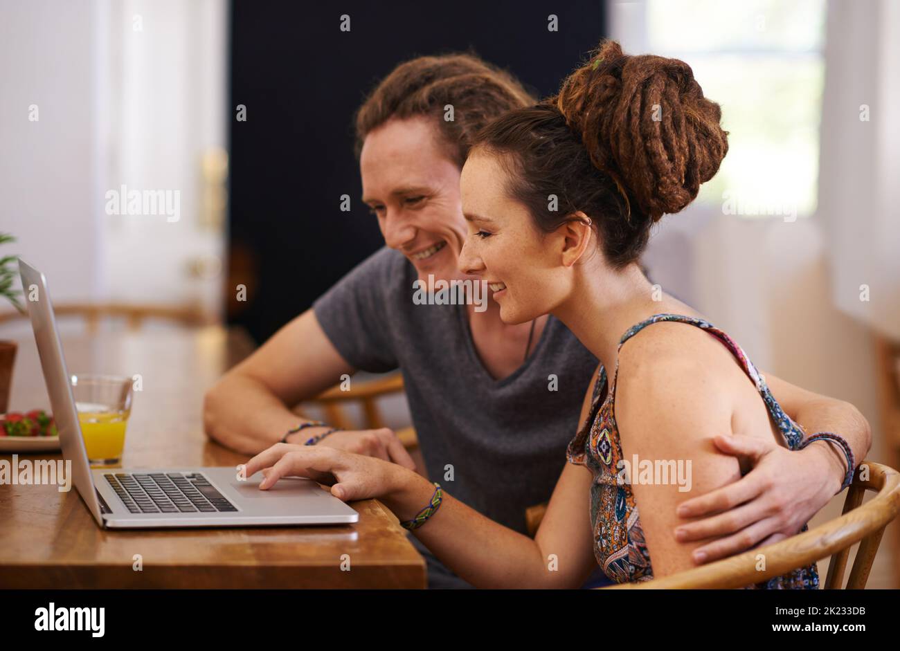 This might be the one. a happy couple with dreadlocks using a laptop ...