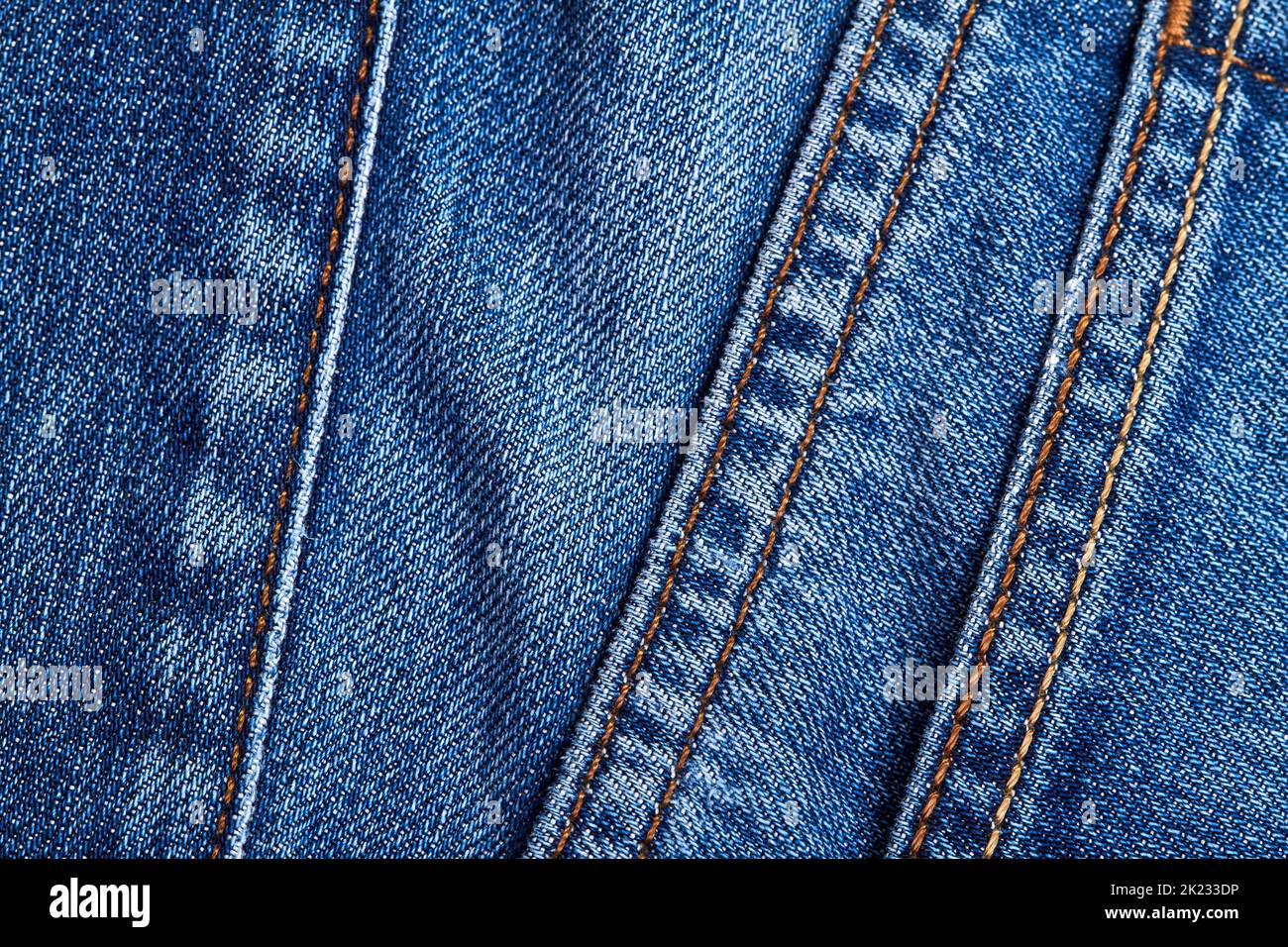 A blue denim jeans texture with seams and orange thread stitches Stock ...