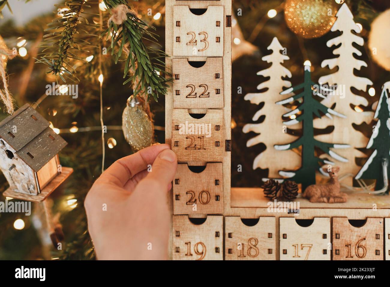 Hand opens wooden advent calendar Stock Photo - Alamy