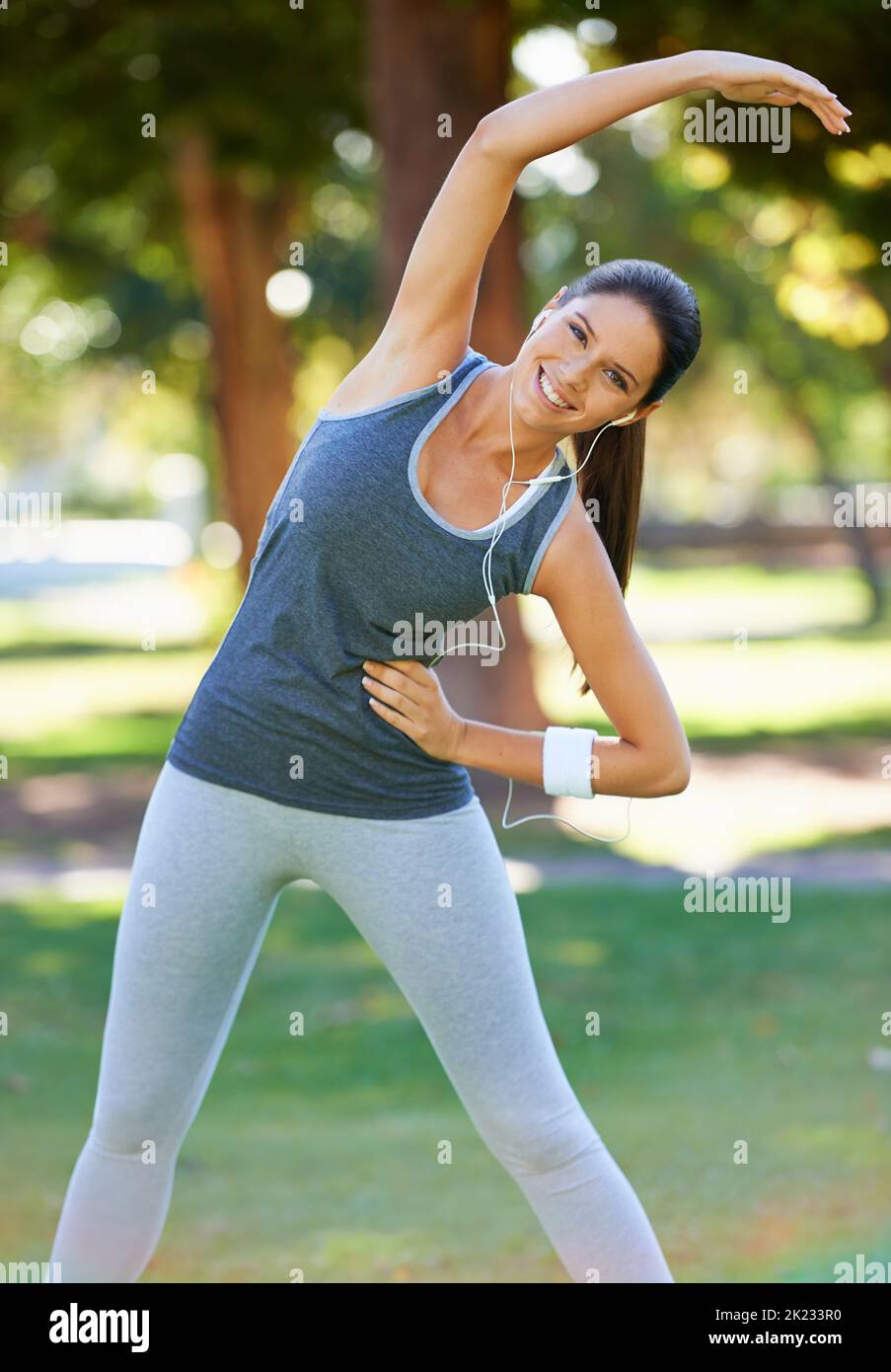 Stretching for the perfect body. Full length shot of a woman stretching ...