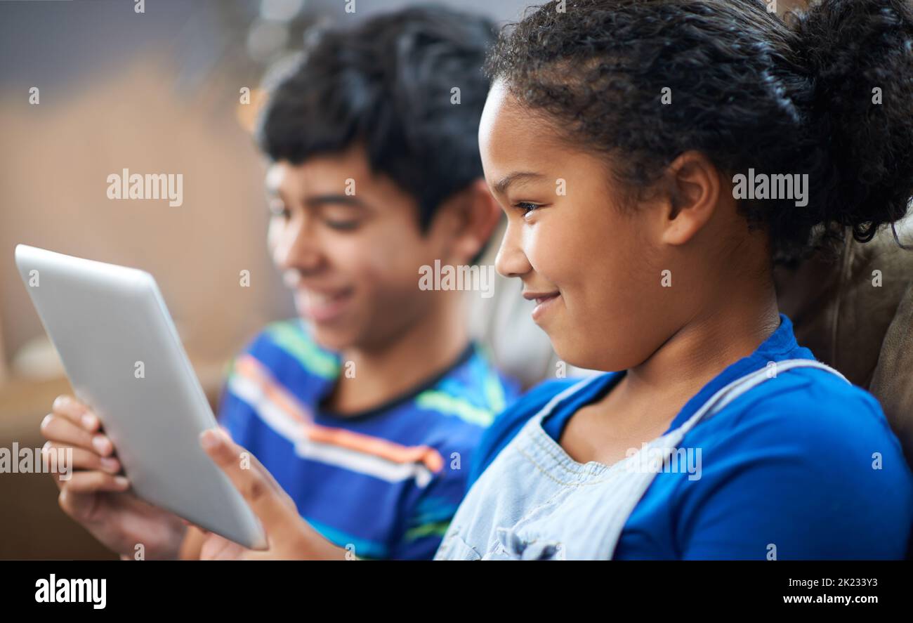 Come watch with me. a little brother and sister watching something on a ...