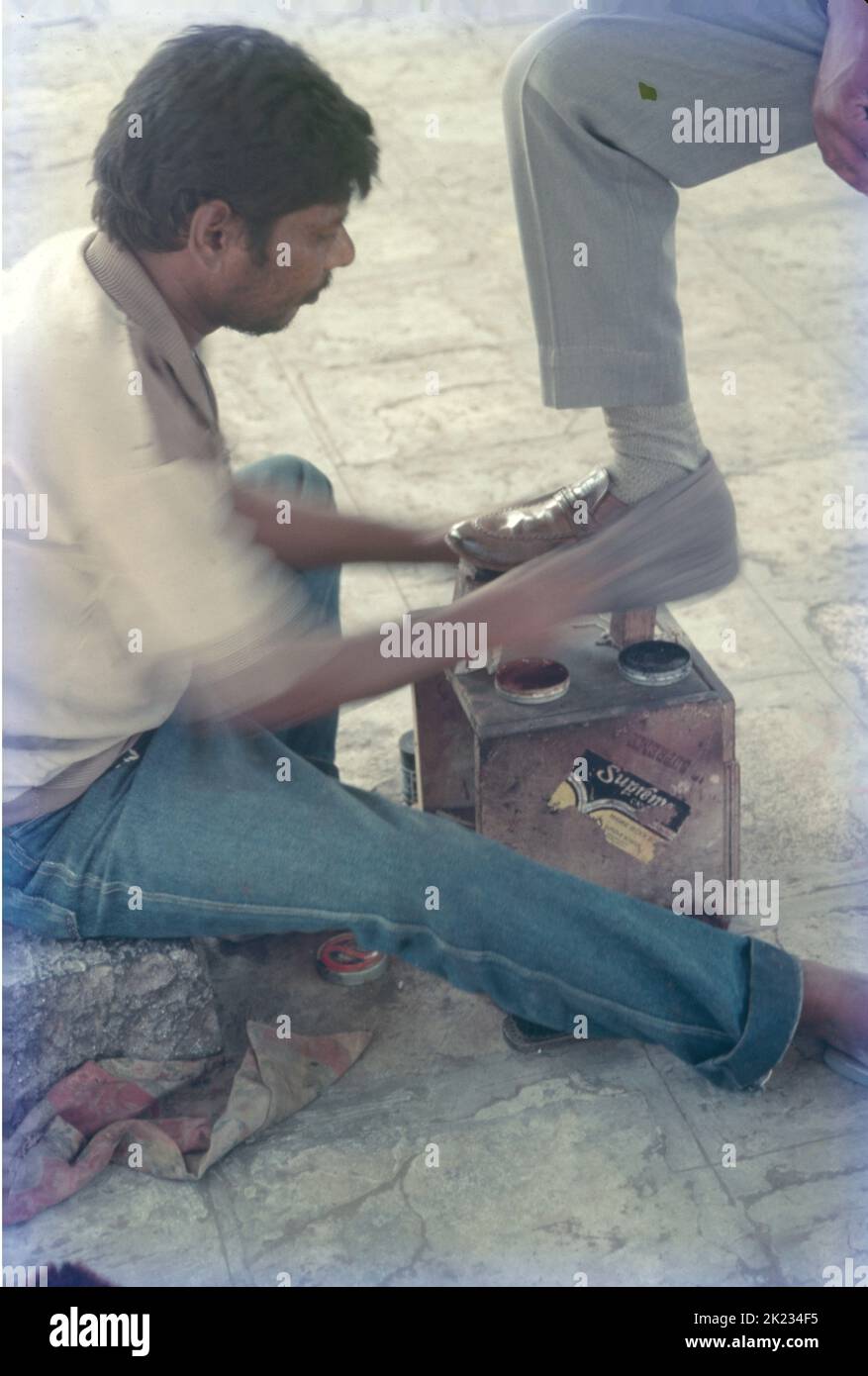 Boot Polisher on Railway Station, Mumbai Stock Photo - Alamy