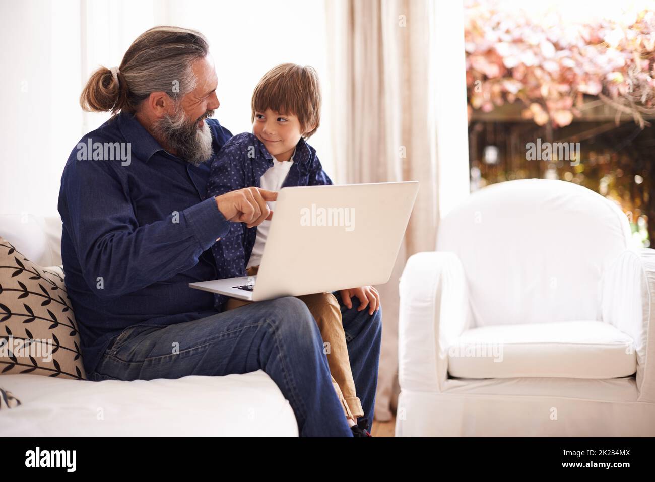 Lets call your parents. a grandfather and grandson using a laptop ...