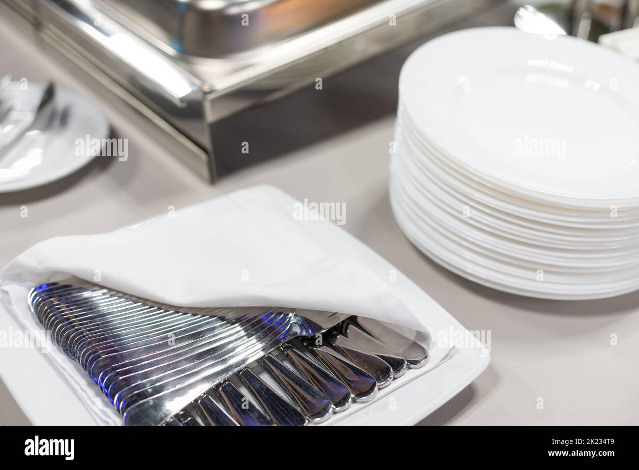 Clean plates, glasses and cutlery on white table Stock Photo - Alamy