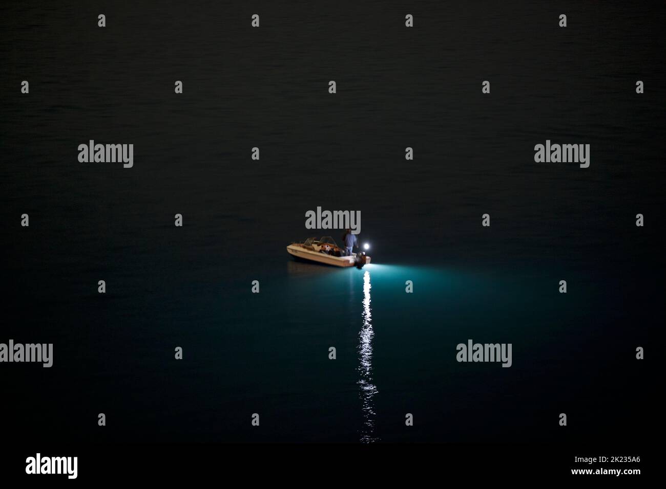 In night fishing, the fisherman uses a gas lamp to attract fish Stock ...