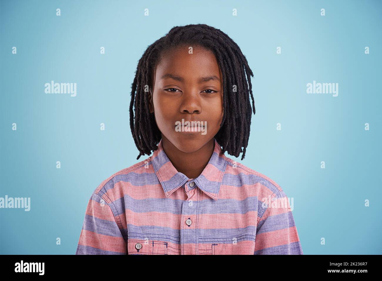 Cool confidence. A portrait of a happy young boy standing in studio ...