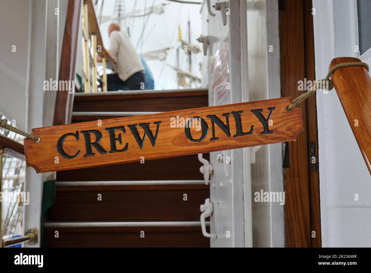 Wooden crew only sign on a ship against a blurred background with ...