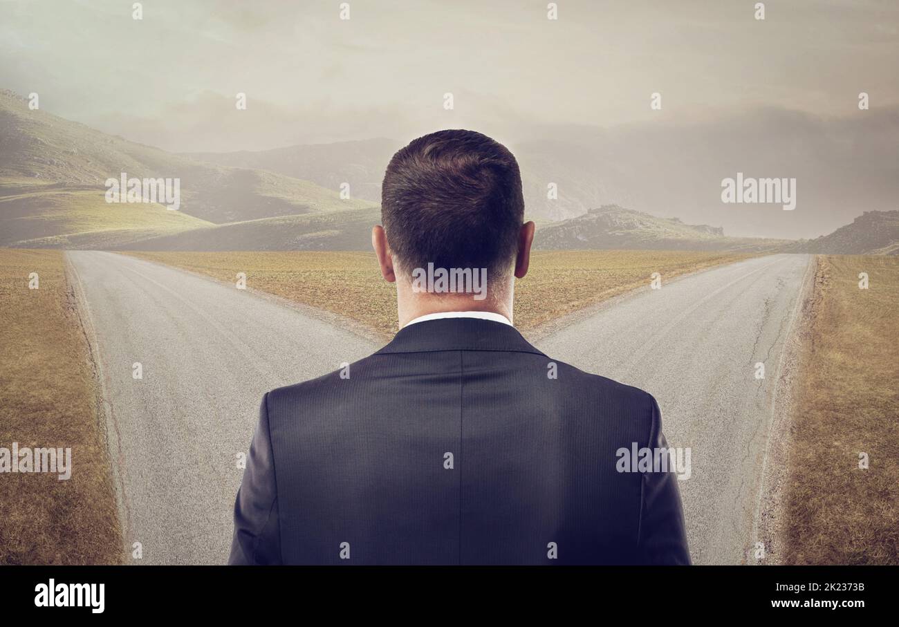 Rearview shot of a well-dressed man standing at a crossroads - ALL ...