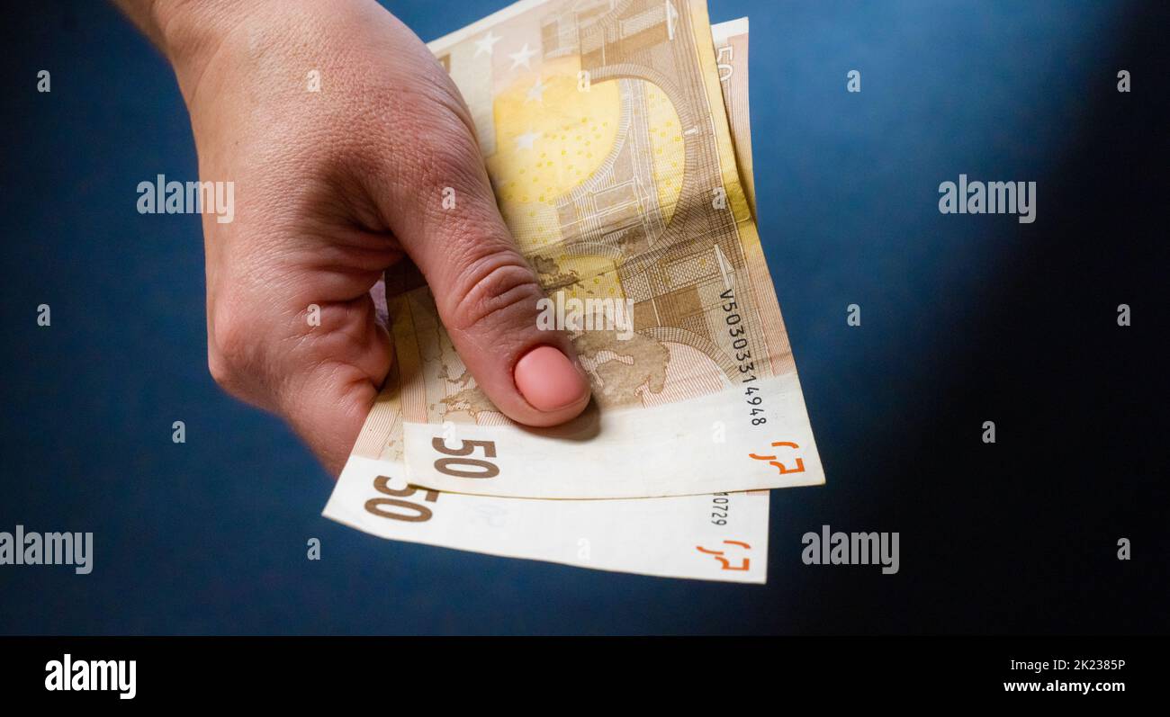 Hand holding banknotes Stock Photo - Alamy