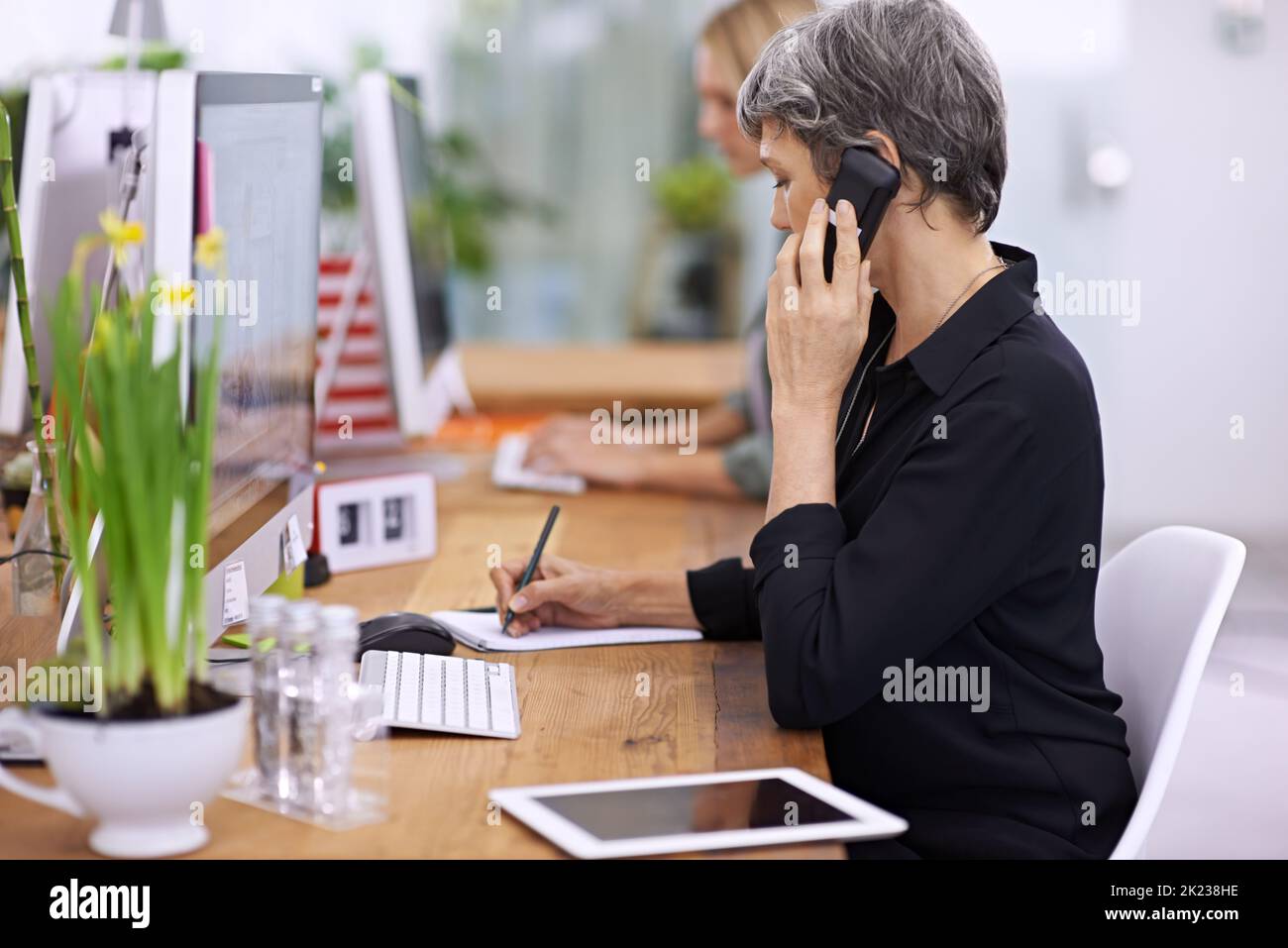 Busy buzz in the workplace. a mature businesswoman having a telephone ...