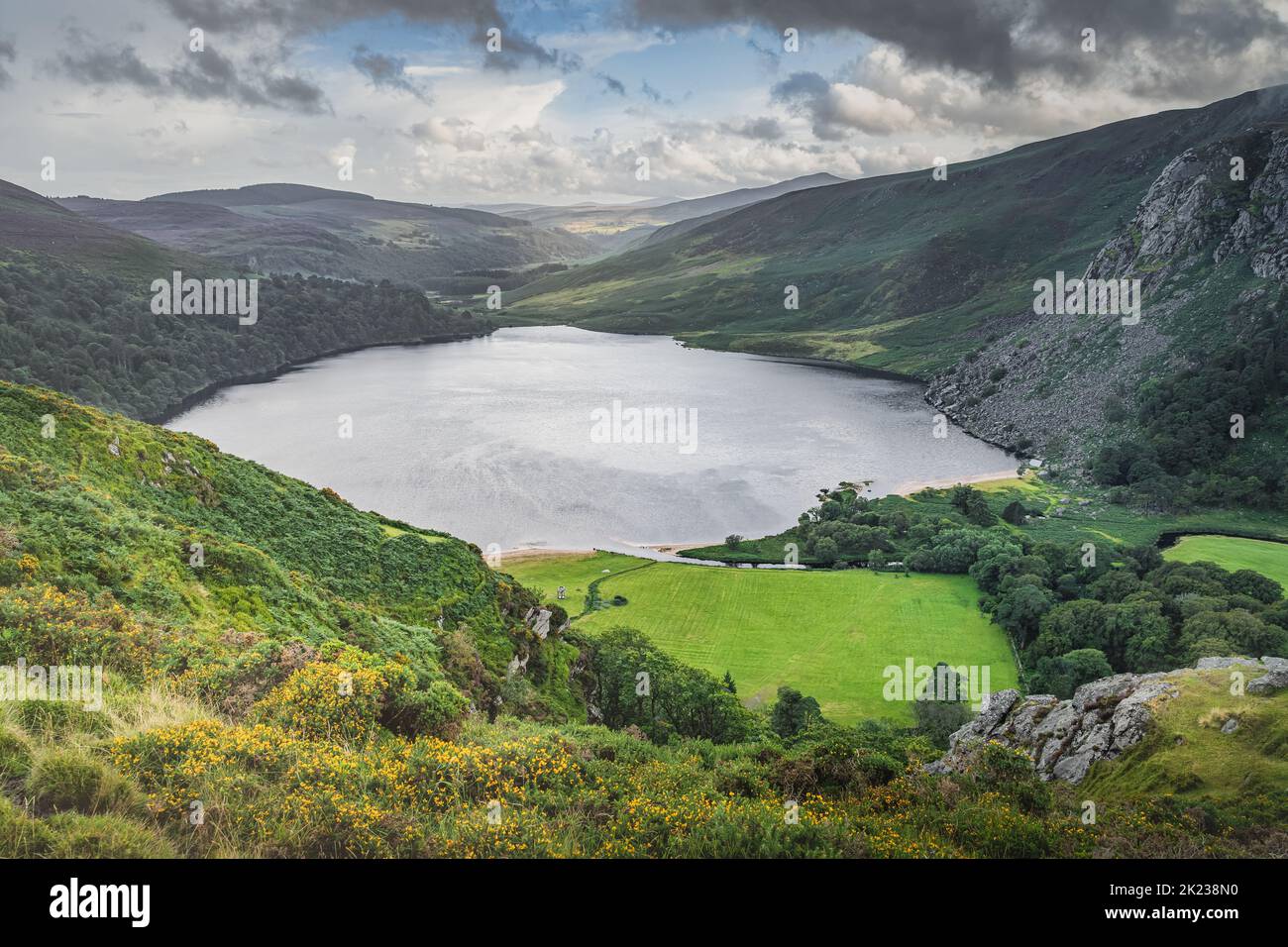 Dramatic sky over Lough Tay called The Guinness Lake in deep valley ...
