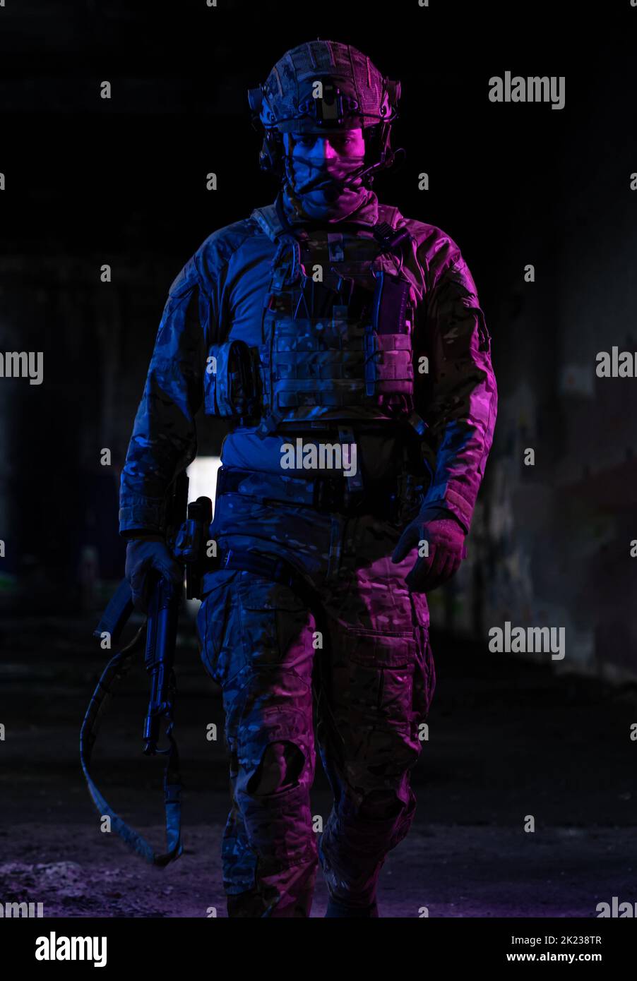 Army soldier in Combat Uniforms with an assault rifle and combat helmet ...