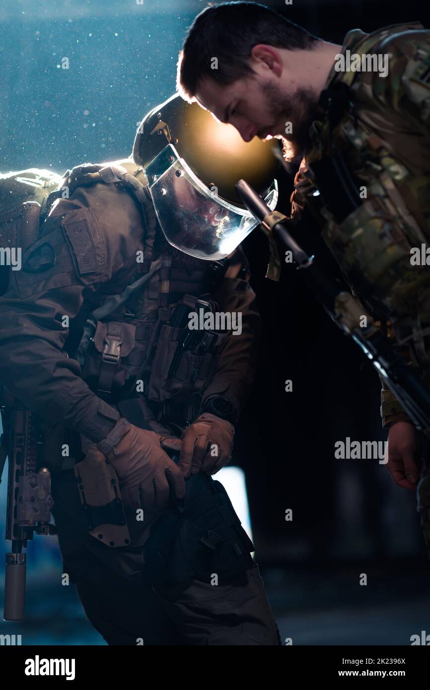 Modern warfare soldiers in dark with combat ammunition and weapons in ...