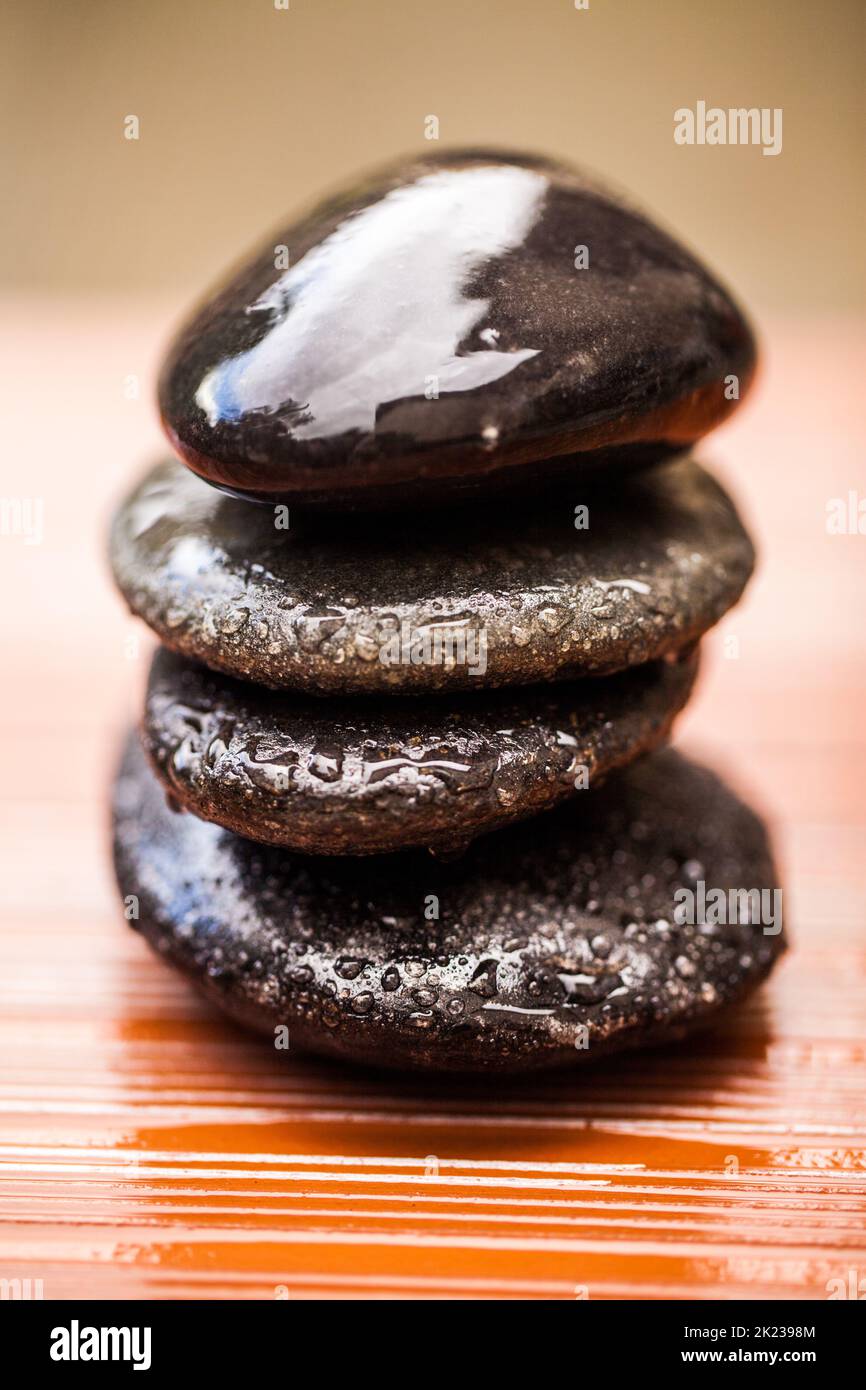 Natural Therapy. Closeup shot of wet lastones stacked on each other ...