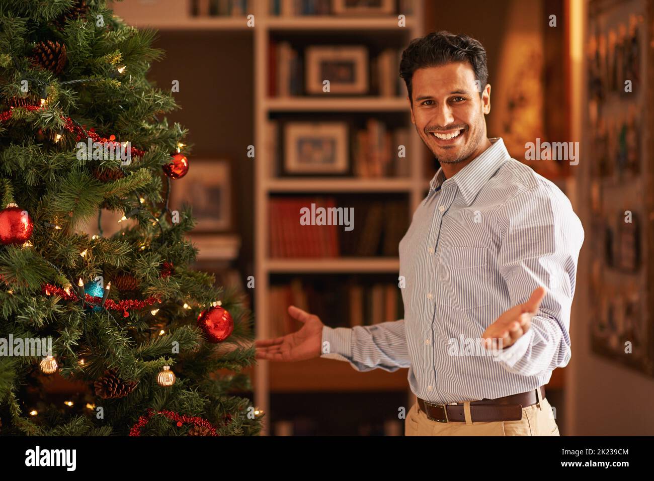 How do you like my decorating skills. a young man gesturing next to a ...