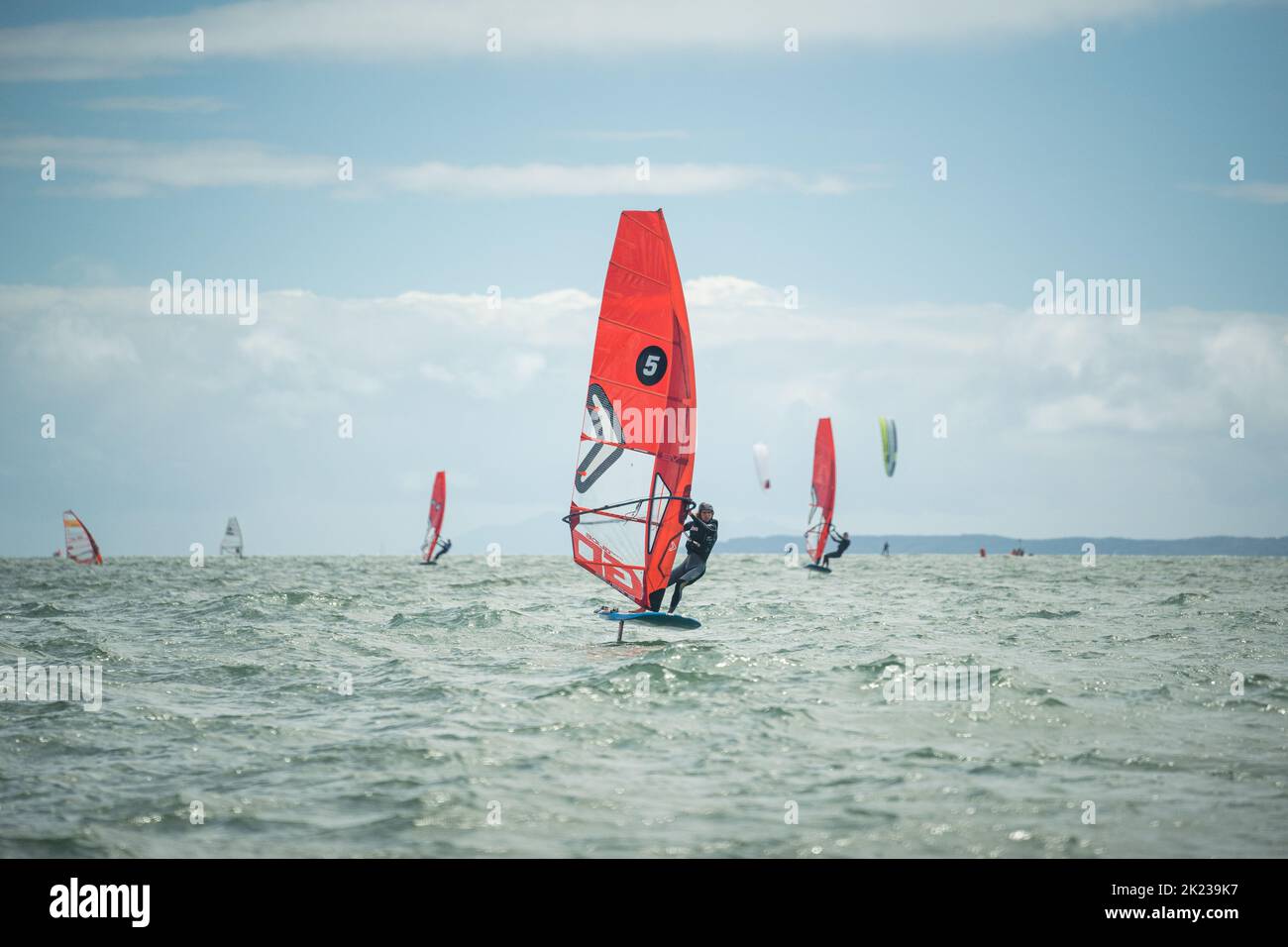 Competitors race in a national windsurfing hydrofoil race at the ...