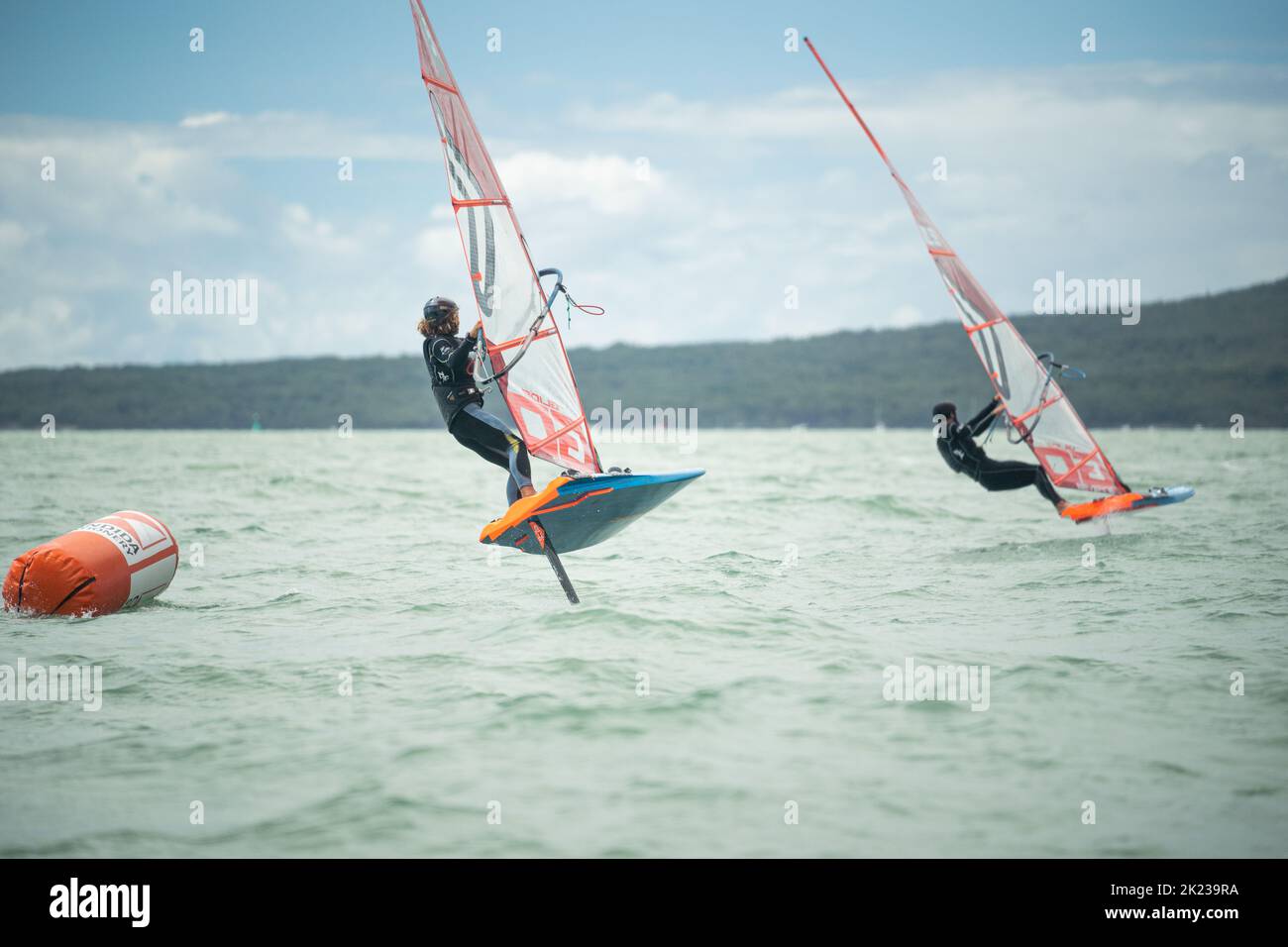 Competitors race in a national windsurfing hydrofoil race at the ...
