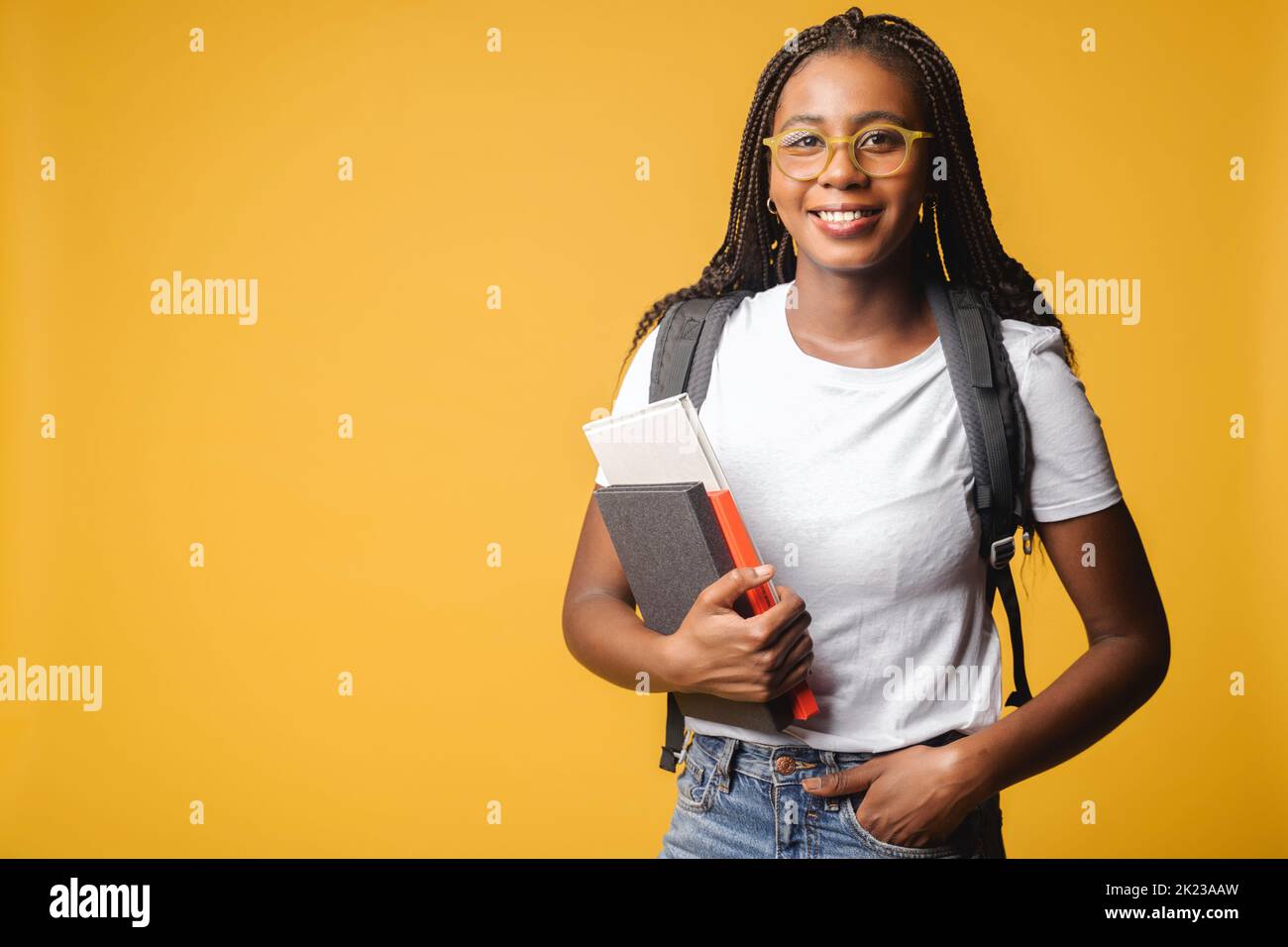 Inspired multiracial female student in white t-shirt and jeans with ...