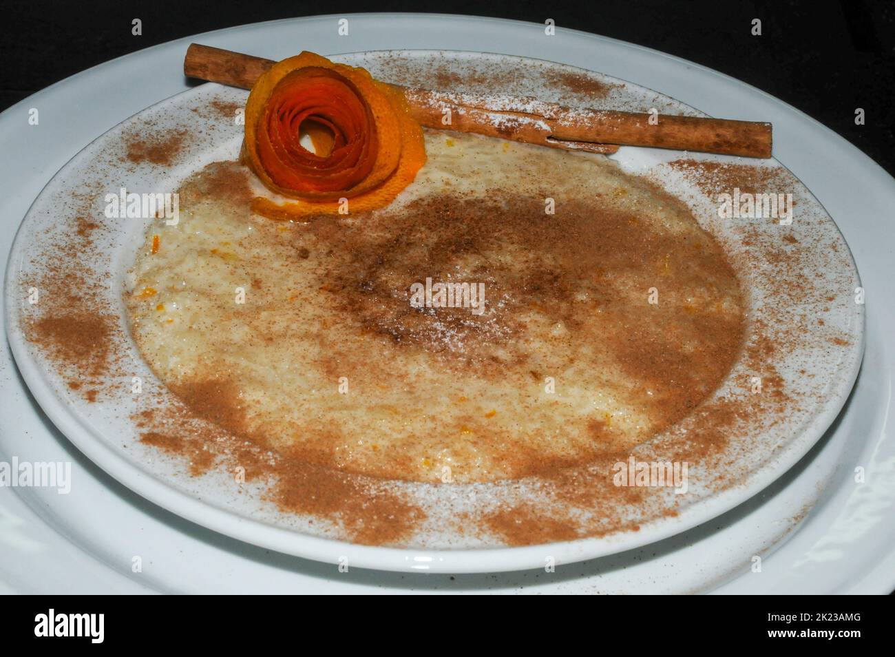 Rice pudding sprinkled with cinnamon, served on a plate Stock Photo - Alamy