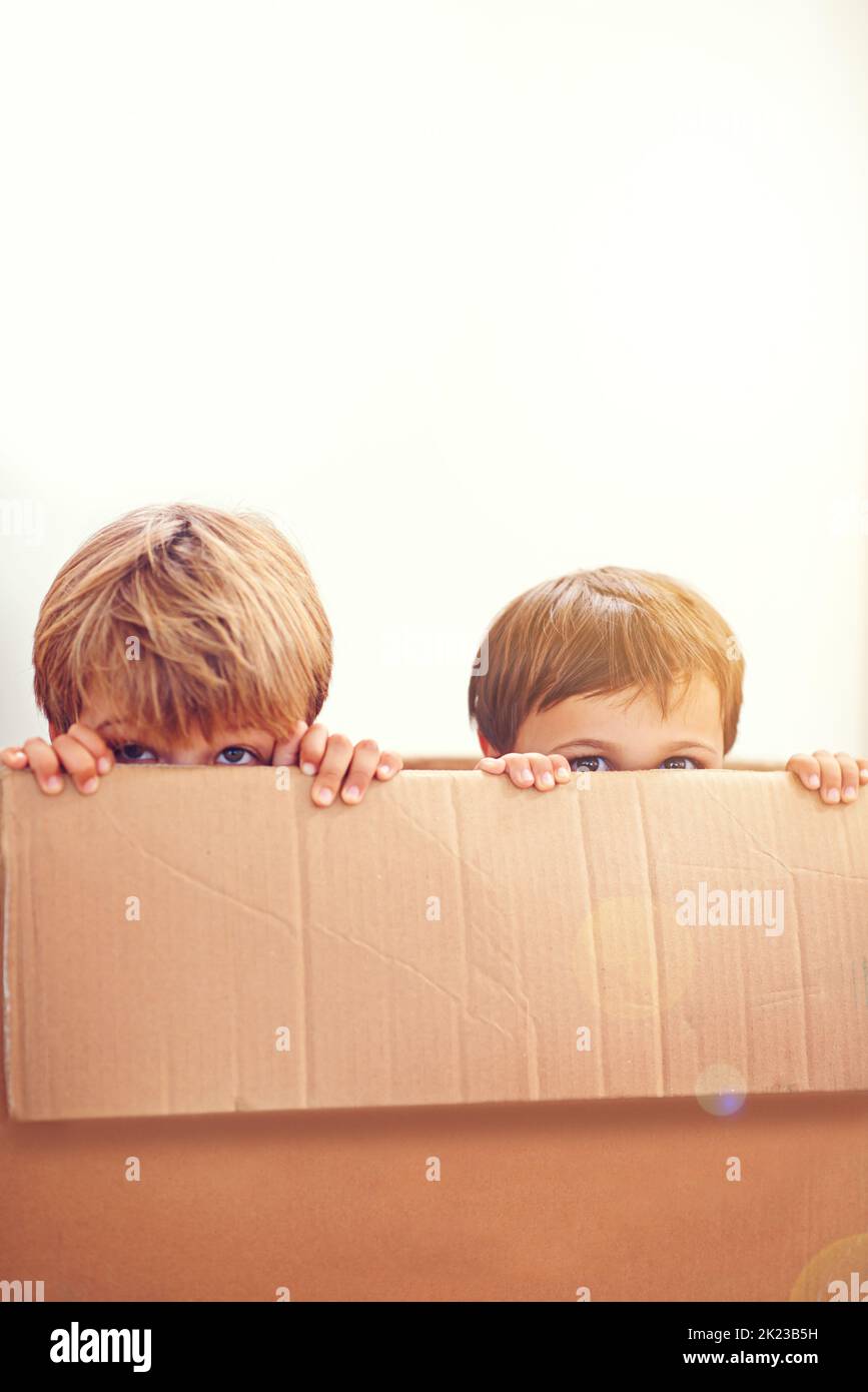 Do you think this is a good hiding spot. Two adorable young boys ...