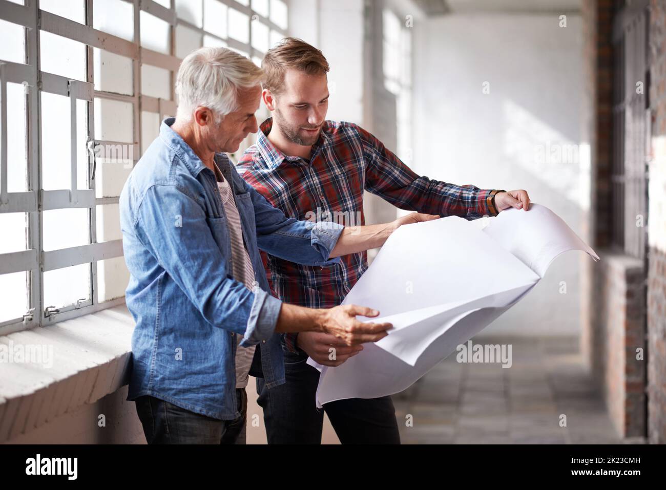 Every beginner architect needs a helping hand. two male architects ...
