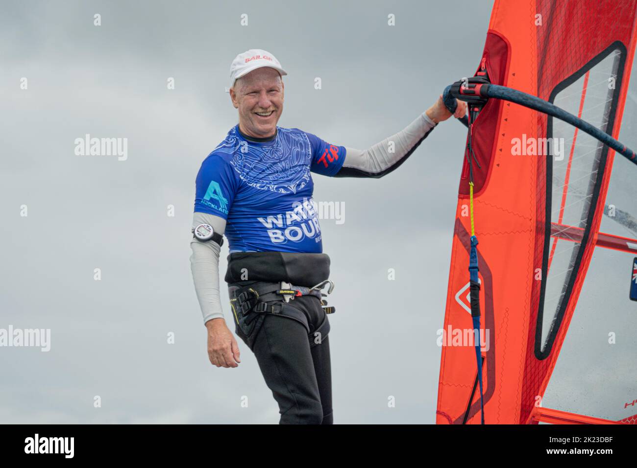 A retired senior man competes in a New Zealand national windsurfing ...