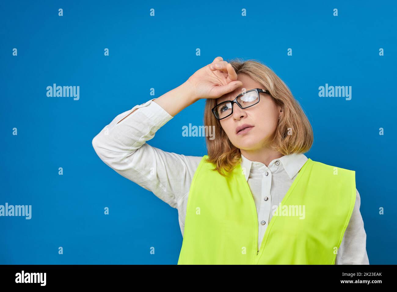 Young female engineer wearing reflective work vest and glasses standing ...