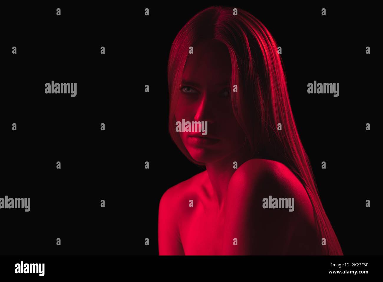 Fantasy. Monochrome. Dark red night. Young sensual woman in neon light ...