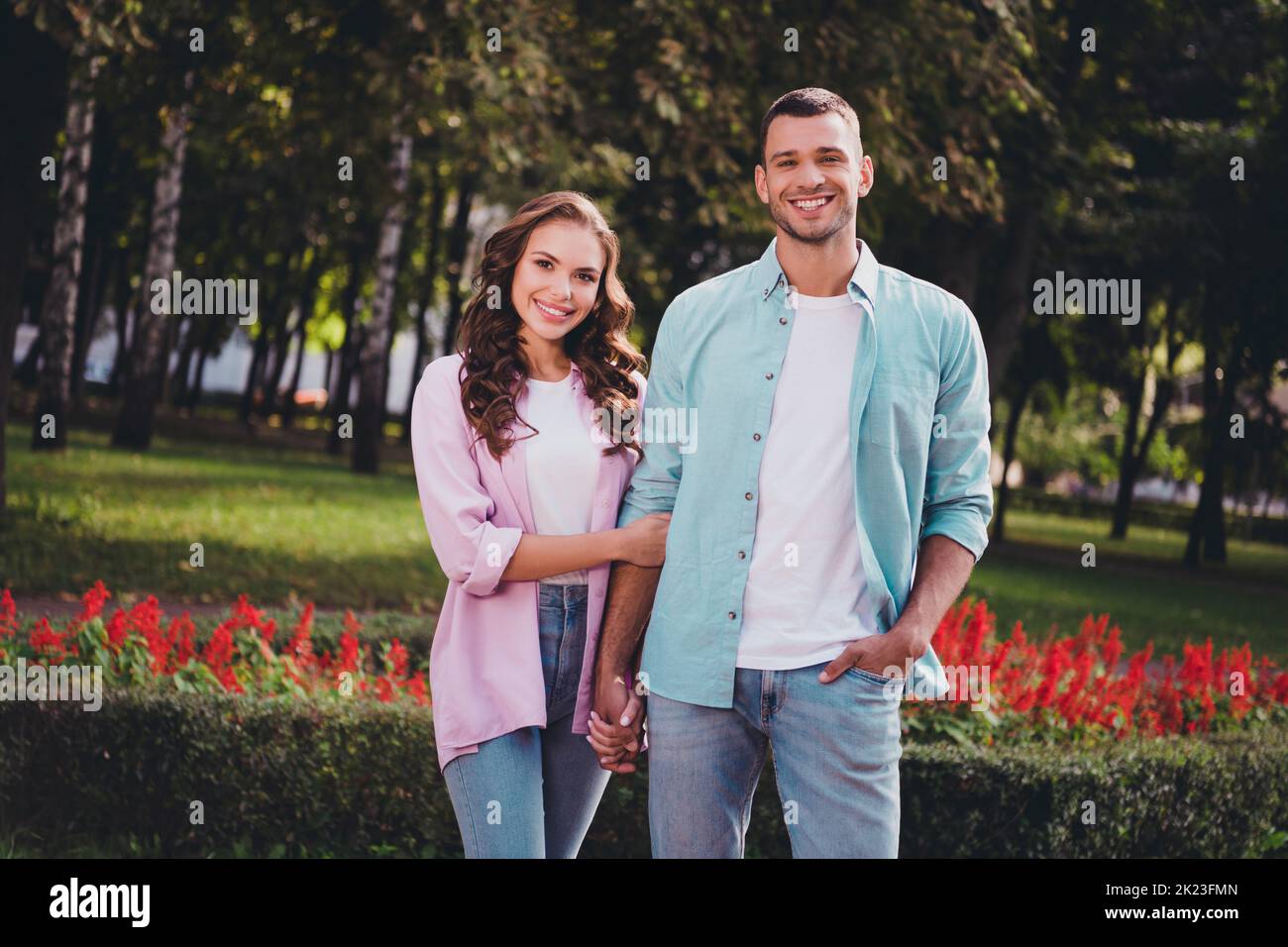 Photo of positive attractive lady handsome man hold arms spend pastime ...