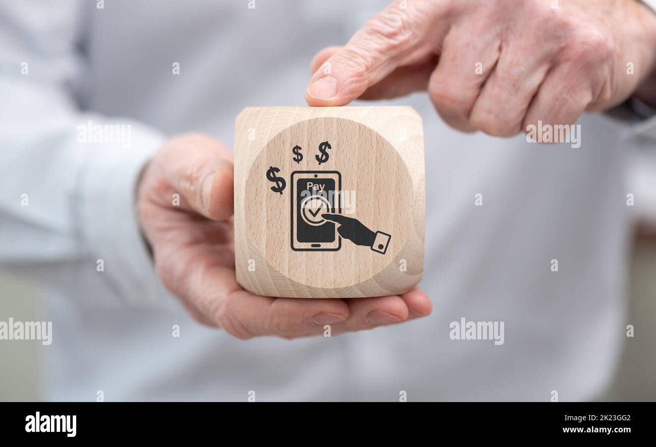 Hand holding a wooden cube with symbol of mobile payment concept Stock ...