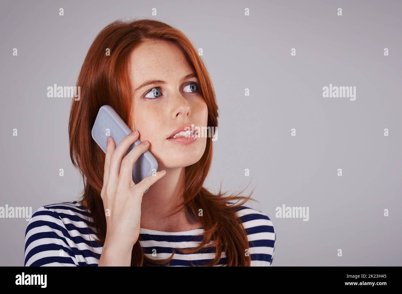 Just a message to make your day. Studio shot of an attractive young red ...