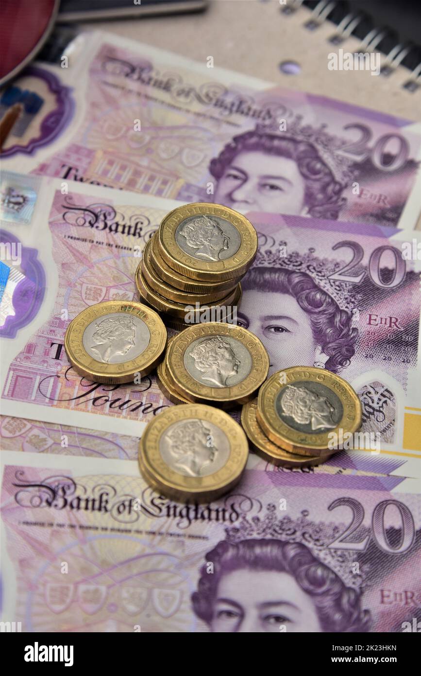 Uk sterling, twenty pound notes and one pound coins pictured. Uk and ...