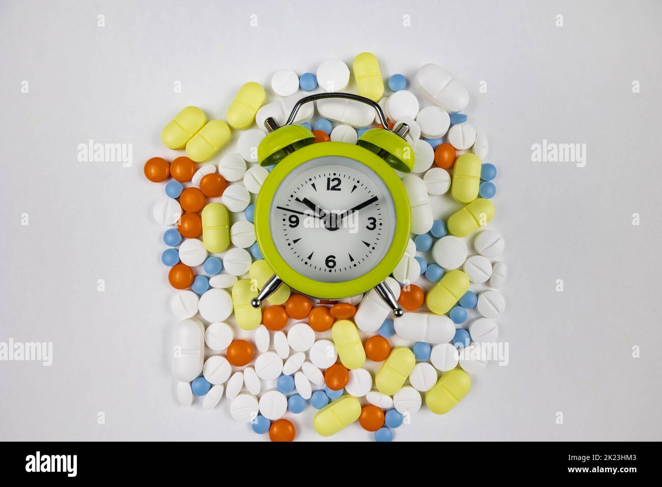 Daily medicine routine concept photo. Pills and a clock isolated on ...