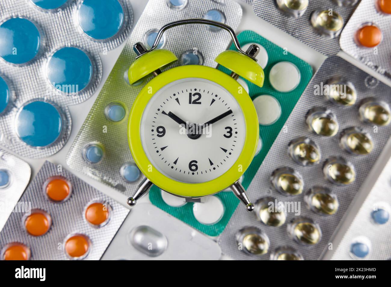 Daily medicine taking routine concept photo with pills and a clock ...