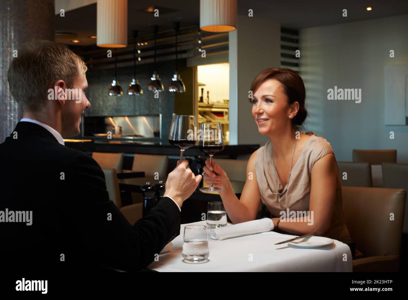 Toasting their marriage. a couple having dinner in a restaurant Stock ...