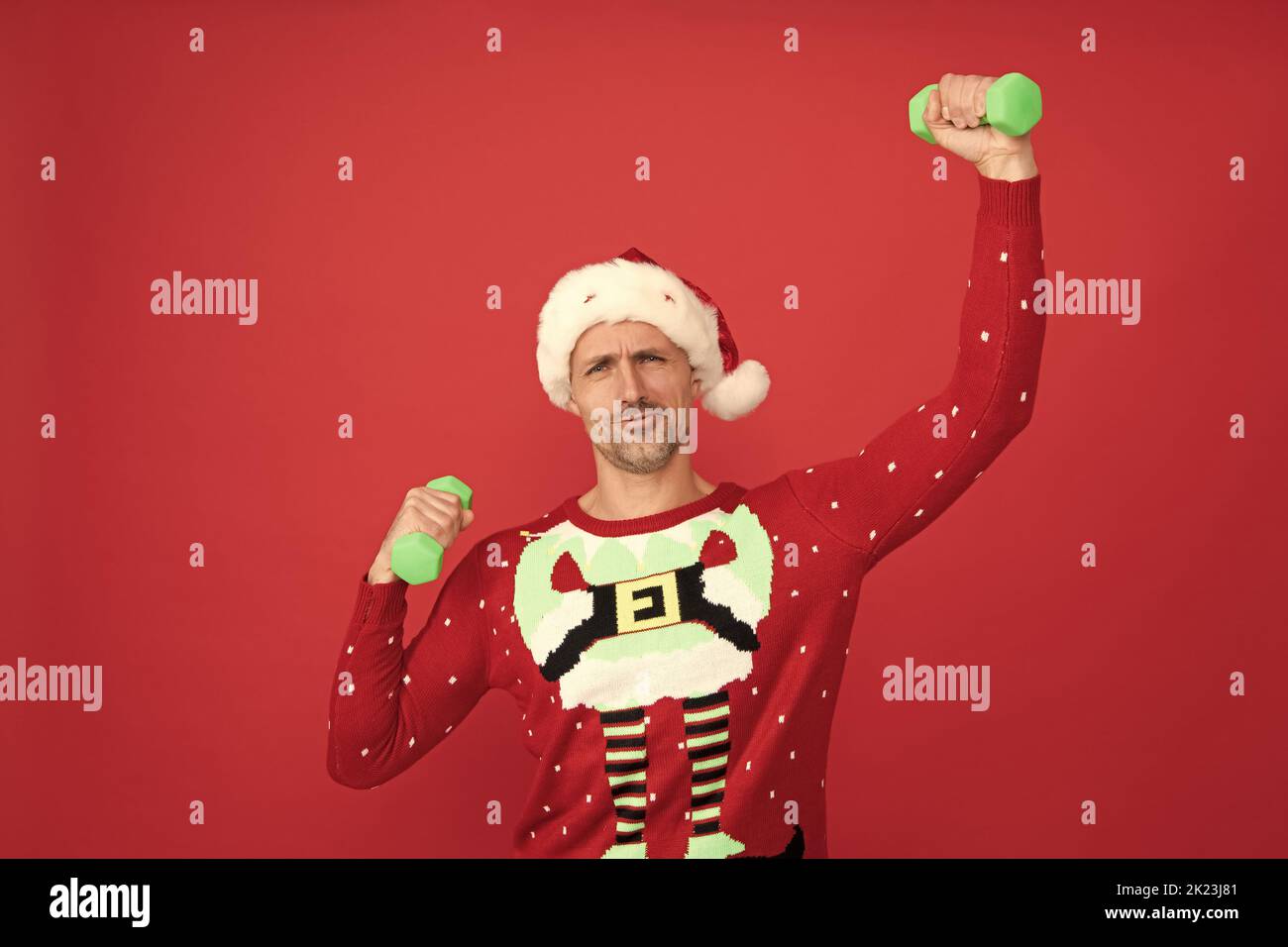 Never too late to be strong. Santa man do dumbbell workout. Christmas ...