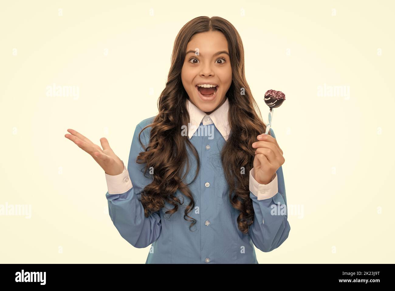 amazed kid portrait has long curly hair hold chocolate sweet isolated ...