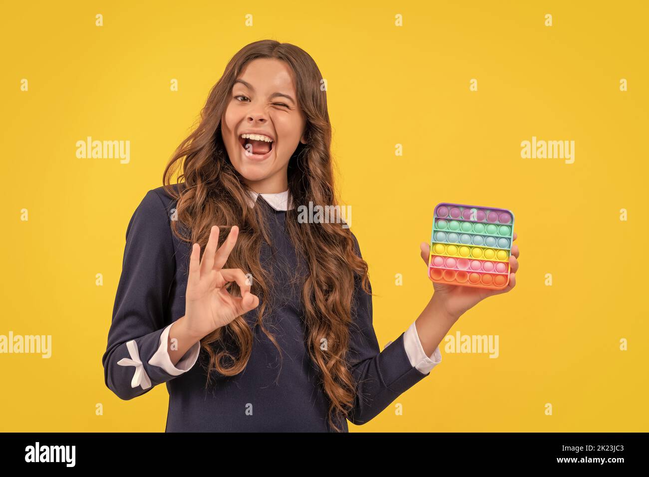 winking kid show ok gesture with popit silicone sensory fidget game ...