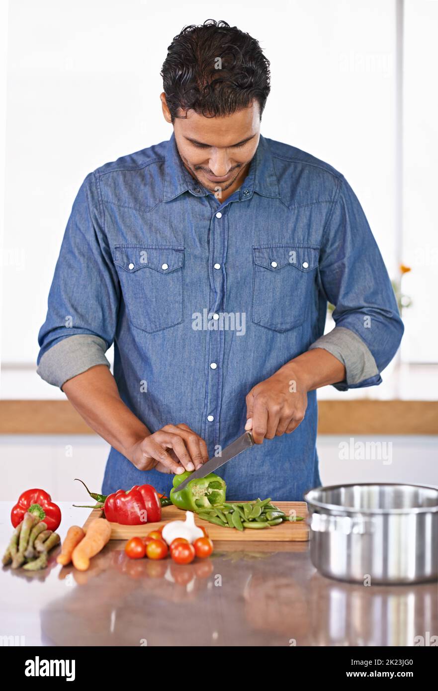 Master chef at work. a man chopping some vegetables on the kitchen ...