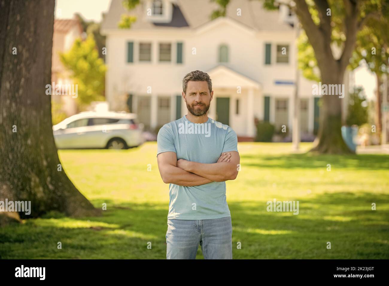 confident unshaven guy standing near new home, buying house Stock Photo ...