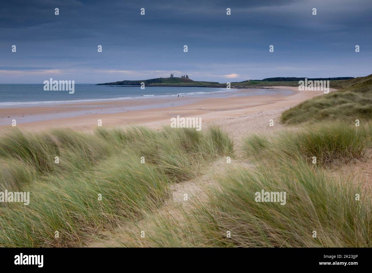 A lone walker on the spectacular beach of Embleton Bay, with ...